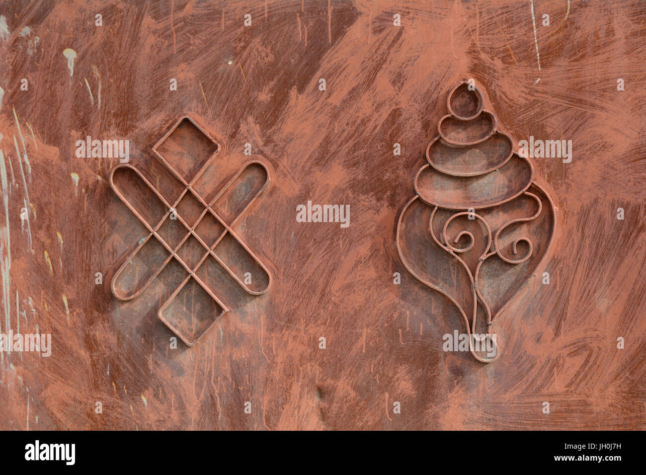Dharma Wheel Buddhist symbol in old door in Ladakh, India. Closed-up ...