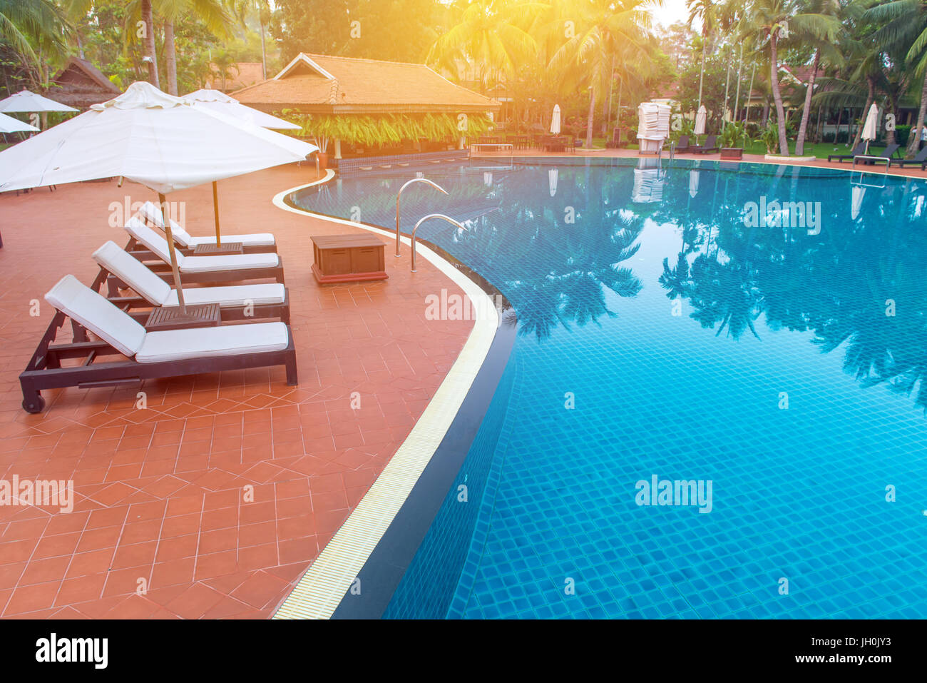 pool bed near swimming pool in tropical resort Stock Photo - Alamy