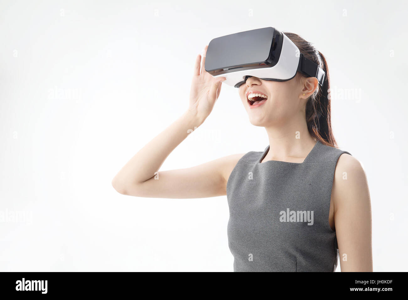 Young woman using virtual reality headset Stock Photo - Alamy