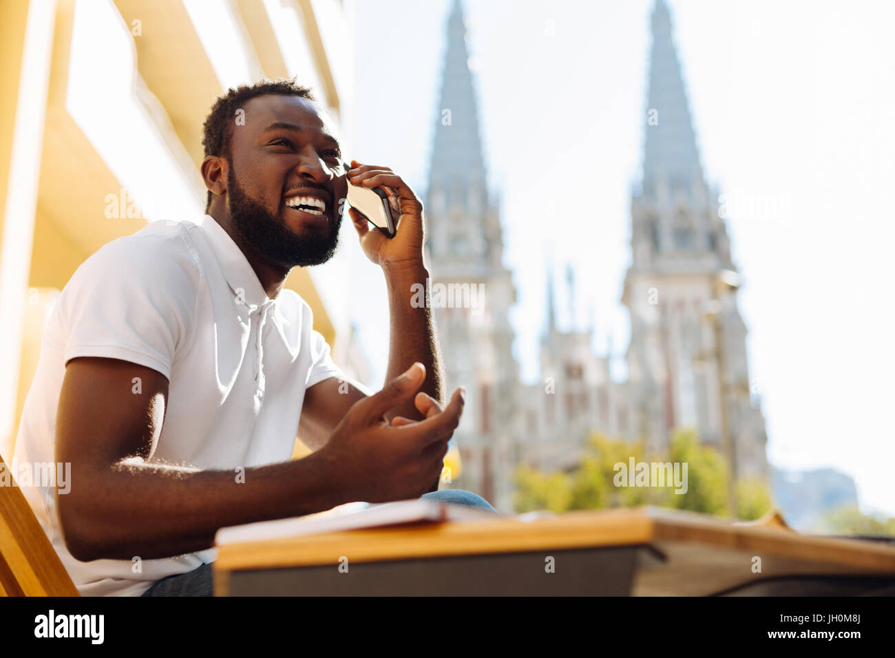 Vibrant sociable man inviting his friend Stock Photo - Alamy