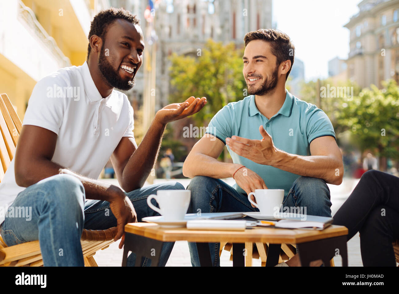 Emotional hilarious guy telling a joke Stock Photo - Alamy