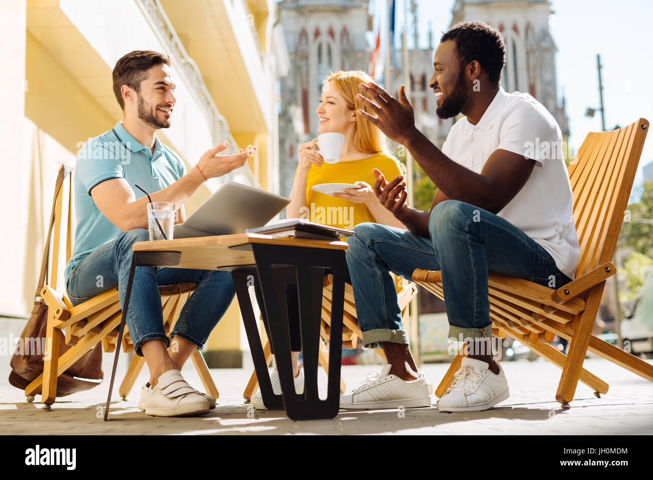 Active lovely friends enjoying a fruitful discussion Stock Photo - Alamy