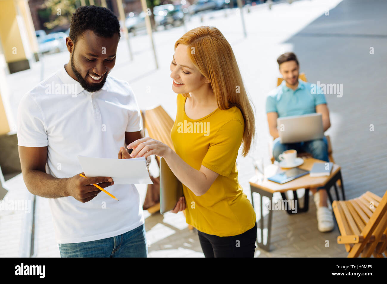 Admirable talented guy showing his notes to a friend Stock Photo - Alamy