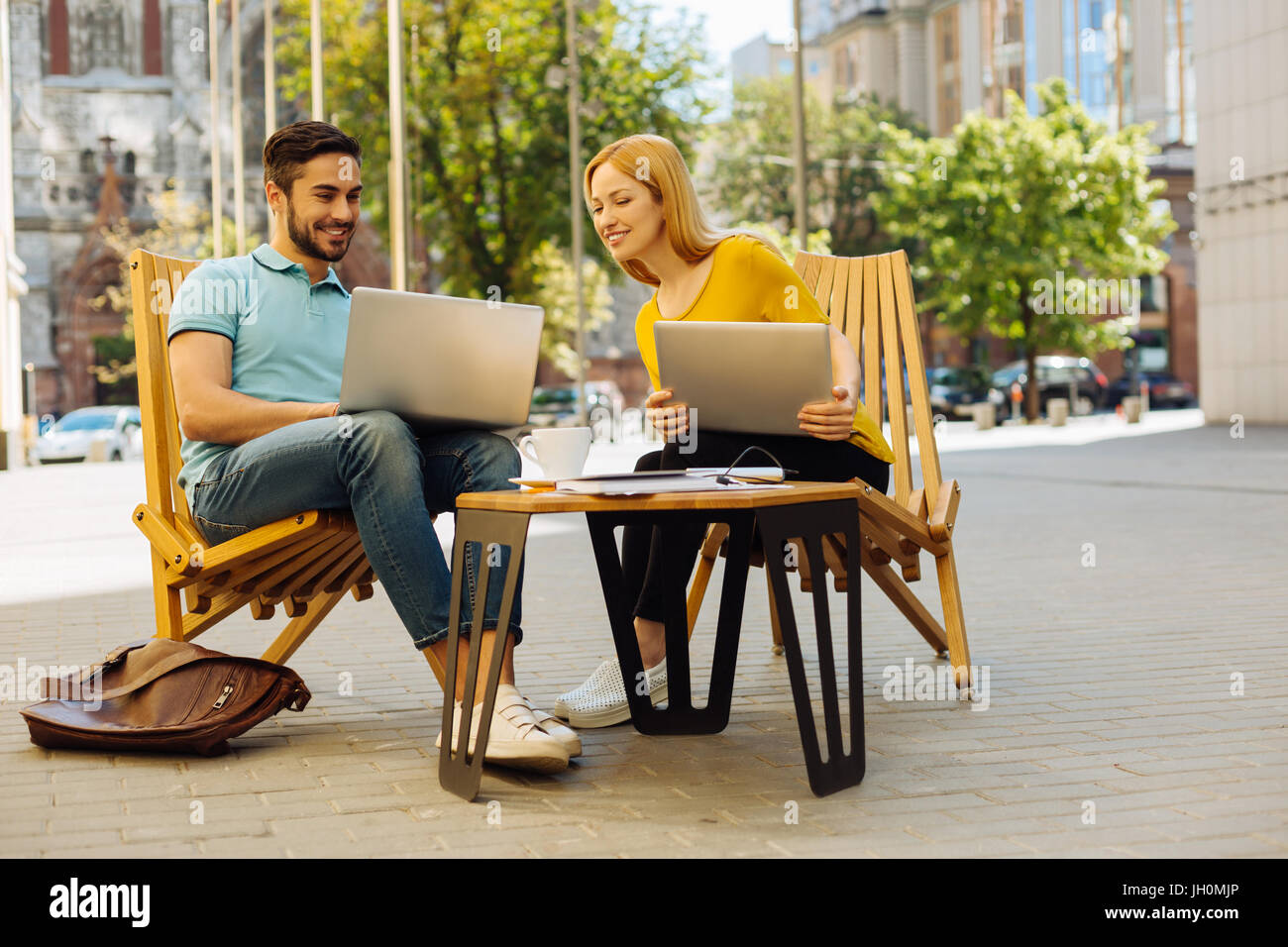 Talented productive people comparing their progress Stock Photo - Alamy