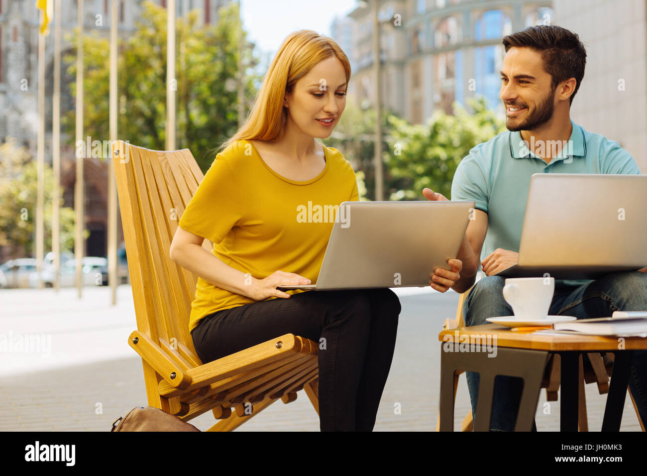 Talented creative guy giving his colleague an advice Stock Photo - Alamy