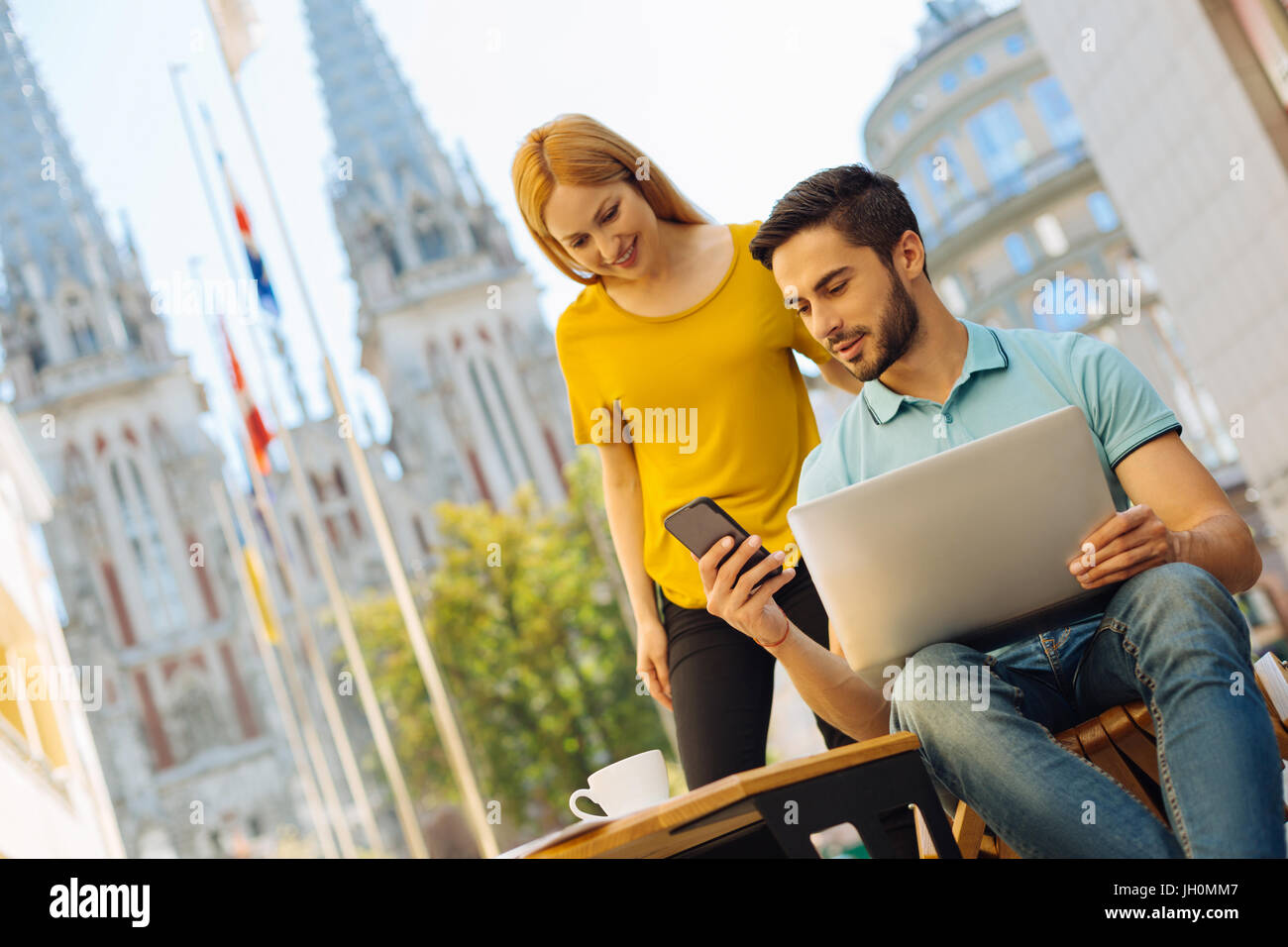 Intelligent enthusiastic man asking his friend having a look Stock ...