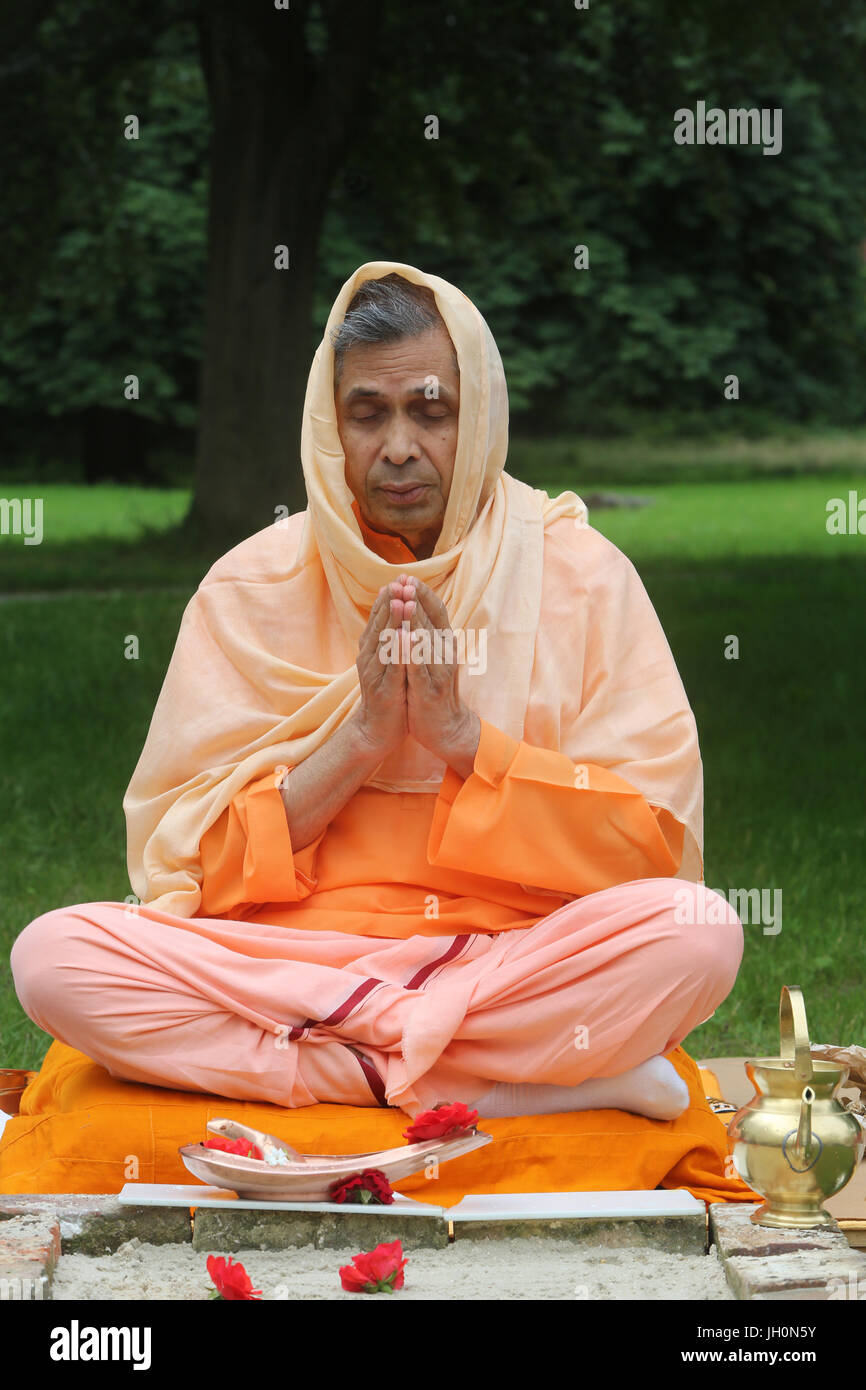 Swami Veetamohanda performing a puja in the garden of the Ramakrishna ...