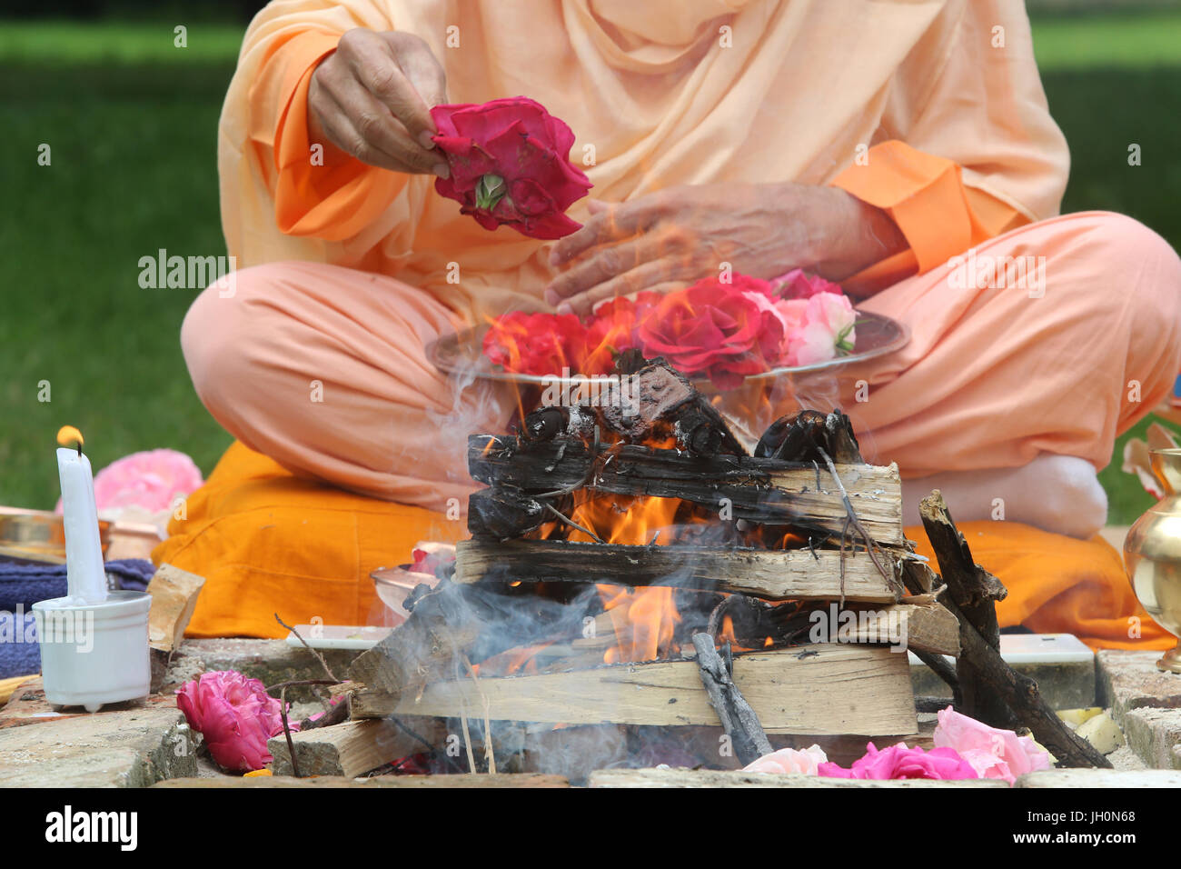 Swami Veetamohanda performing the homa fire ritual in the garden of the ...