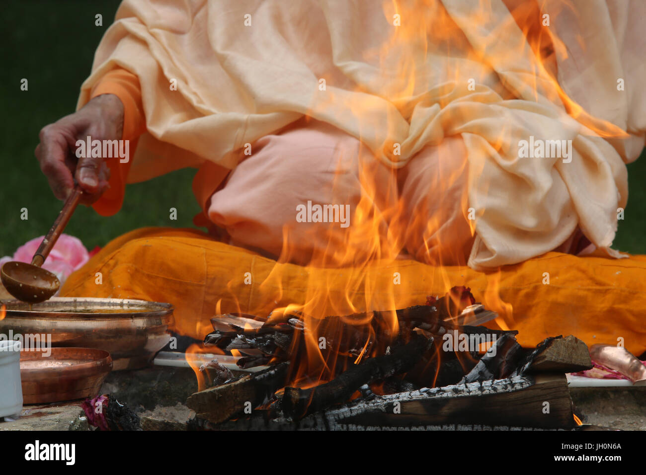 Swami Veetamohanda performing the homa fire ritual in the garden of the ...