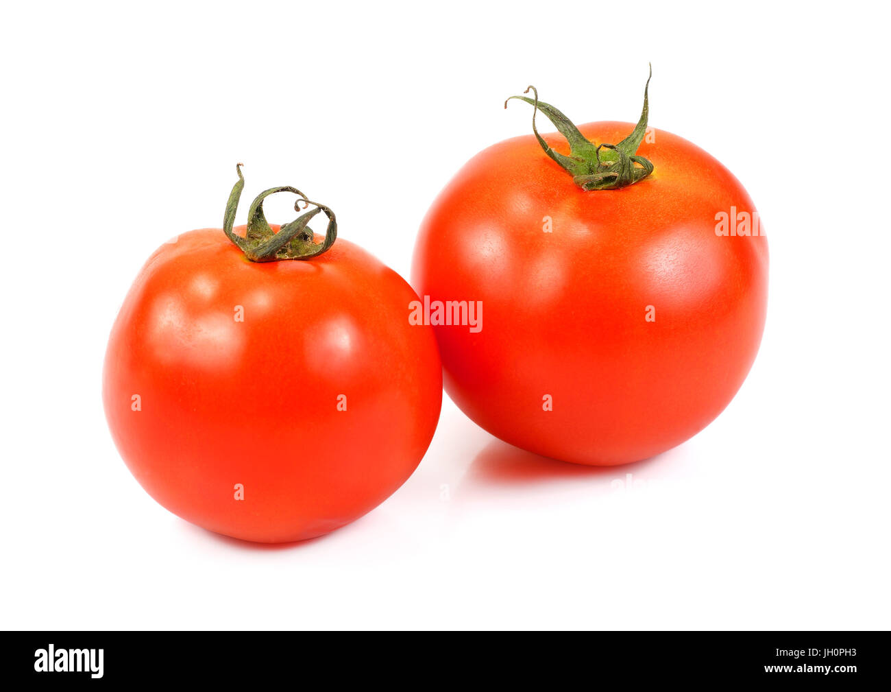 Two tomatoes isolated on a white background Stock Photo - Alamy