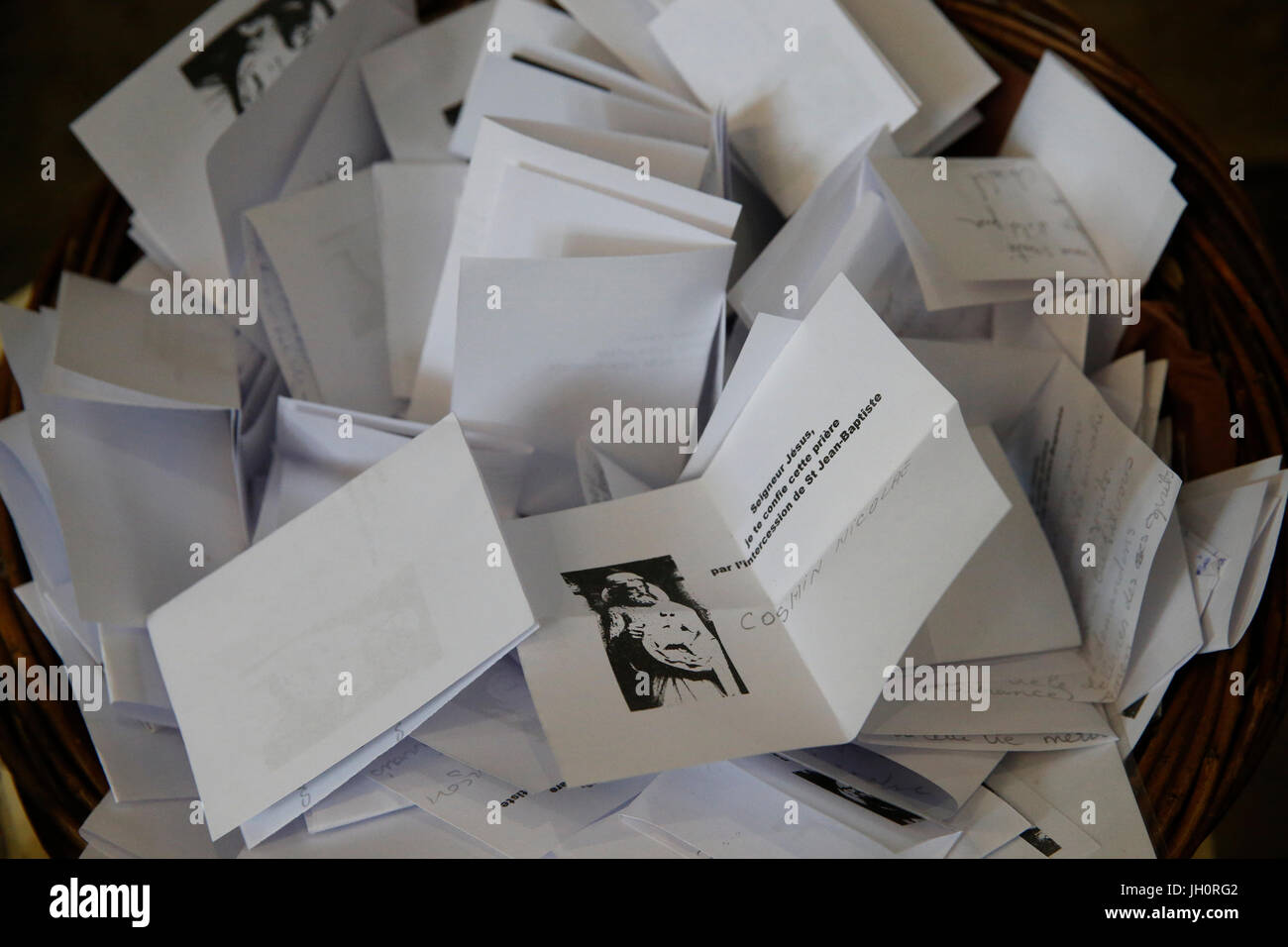 Written prayers in a catholic church. Paris. France Stock Photo - Alamy