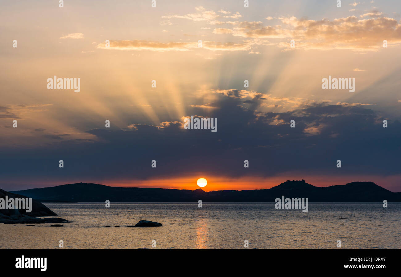 Glorious sunset and sun rays near Baya Sardinia, Sardinia, Italy Stock ...