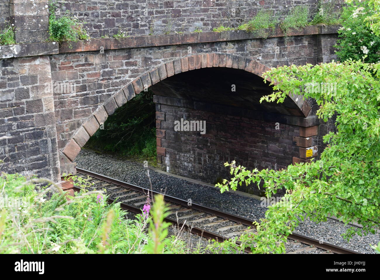 Arched bridge over railway Stock Photo - Alamy