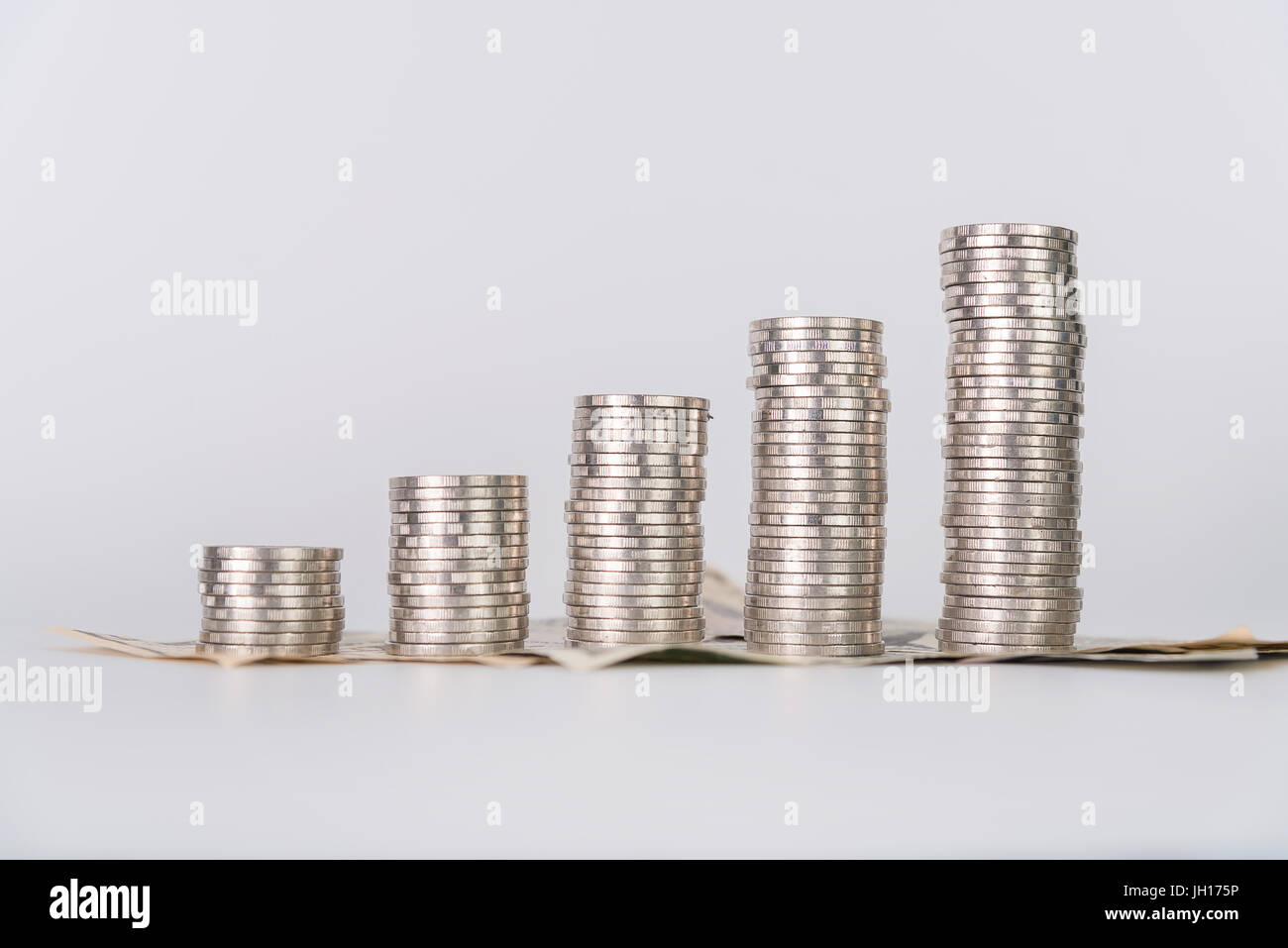 Savings, increasing columns of coins, piles of coins arranged as a ...