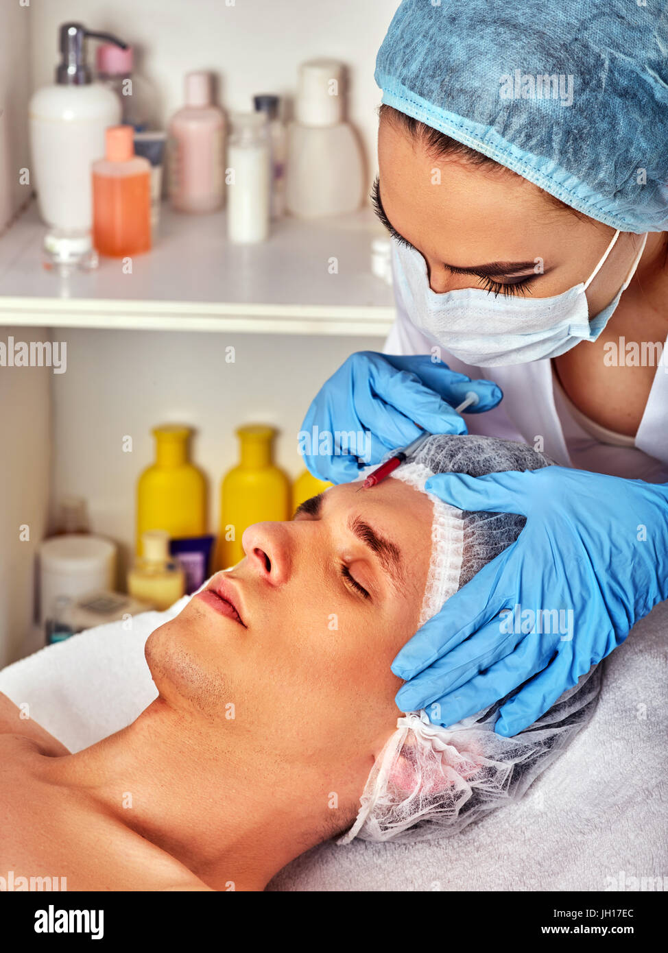 Dermal fillers of man in spa salon with beautician Stock Photo - Alamy