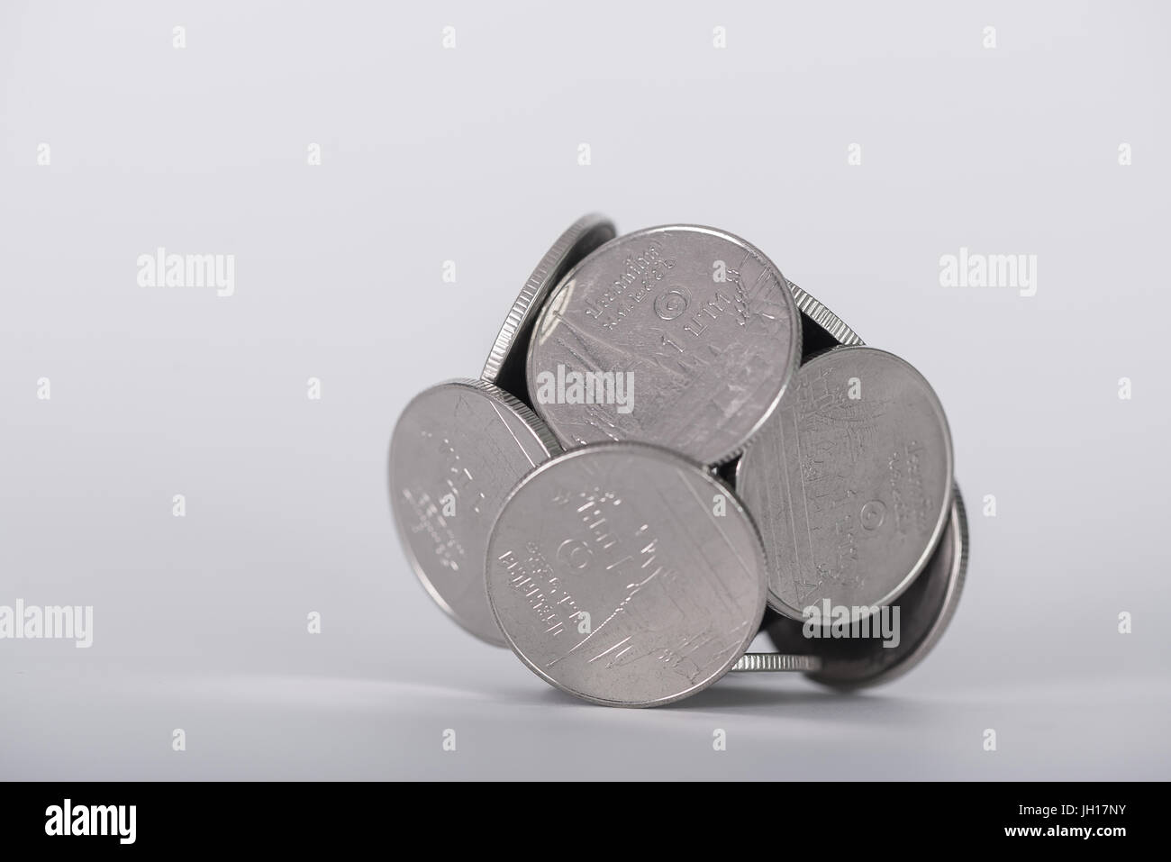 Group of coins, piles of coins arranged ball shape on white background ...