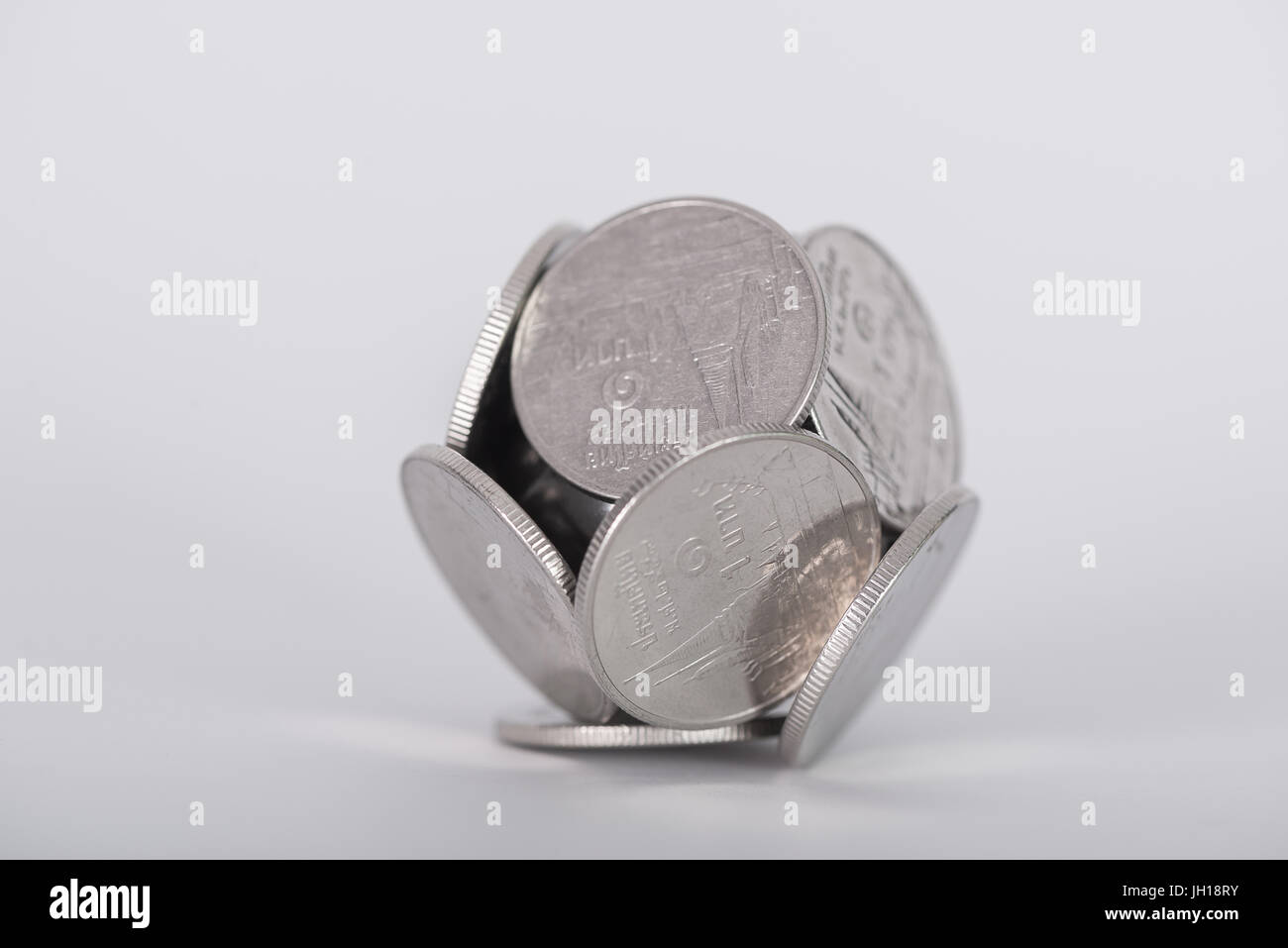 Group of coins, piles of coins arranged ball shape on white background ...