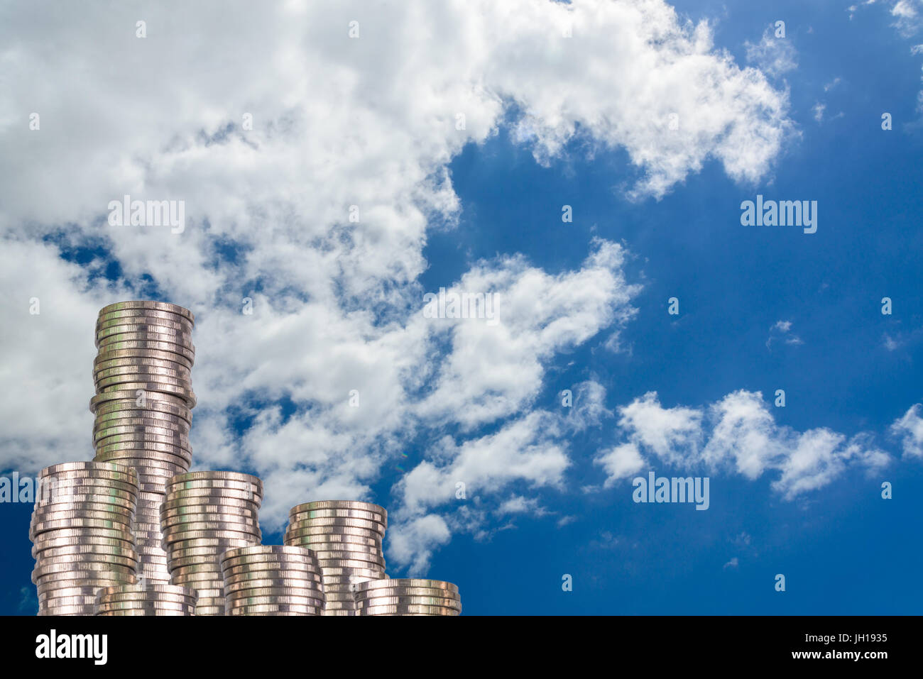 Savings, columns of coins, piles of coins arranged as a graph on blue ...
