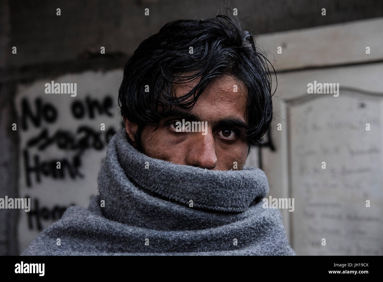 Afghan refugee keep warm by wrapping up in UNHCR blankets. The Barracks ...