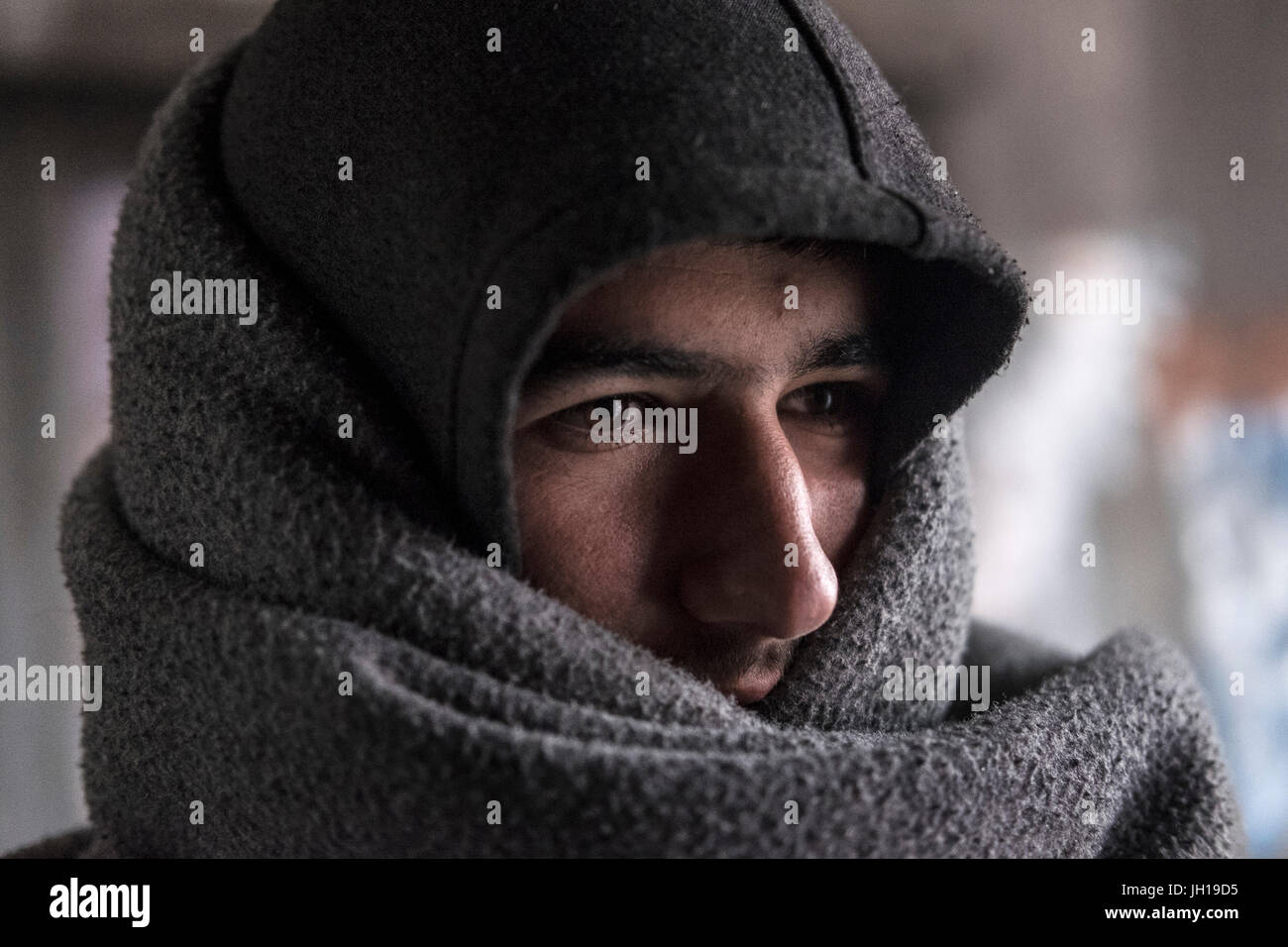 Afghan refugee keep warm by wrapping up in UNHCR blankets. The Barracks ...