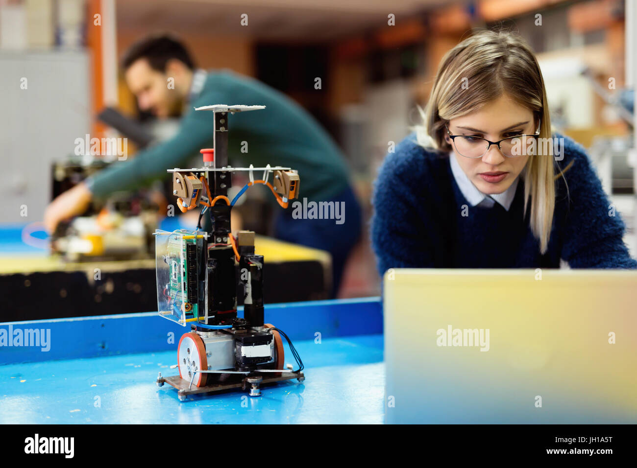 Young engineer testing his robot in workshop Stock Photo - Alamy