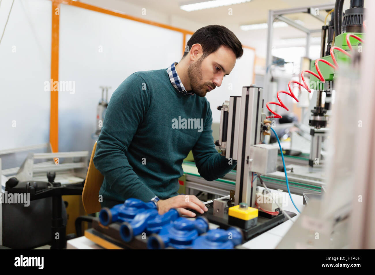 Two young handsome engineers working on electronics components Stock ...