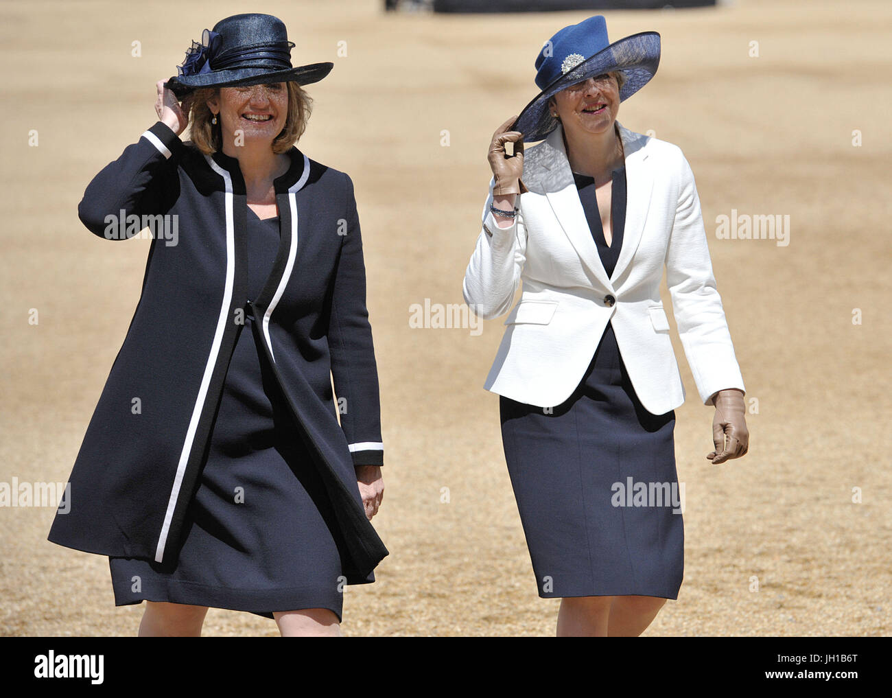 Prime Minister Theresa May and Home Secretary Amber Rudd (left) hold ...
