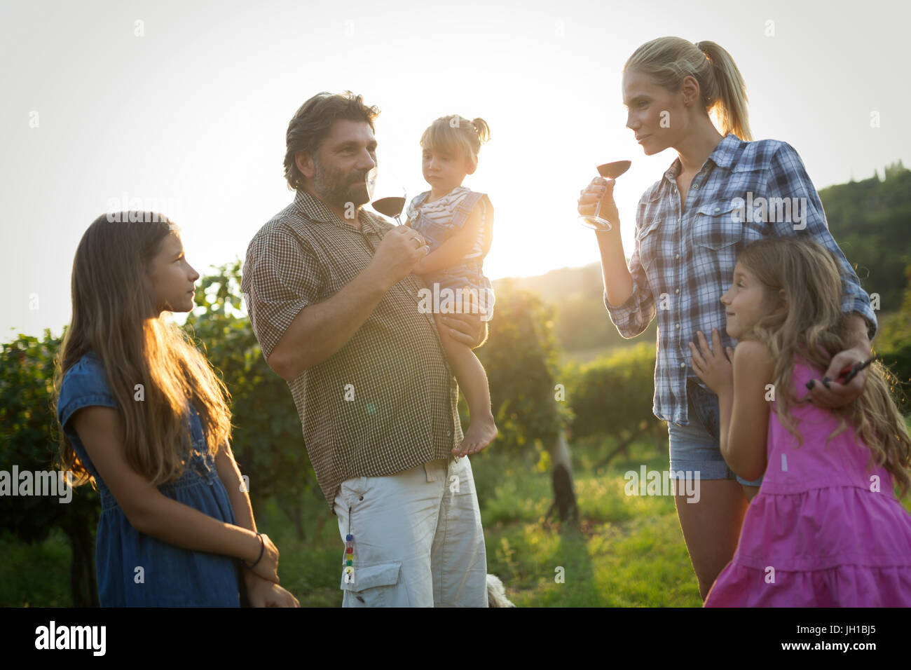 Wine grower family in vineyard before harvesting Stock Photo - Alamy
