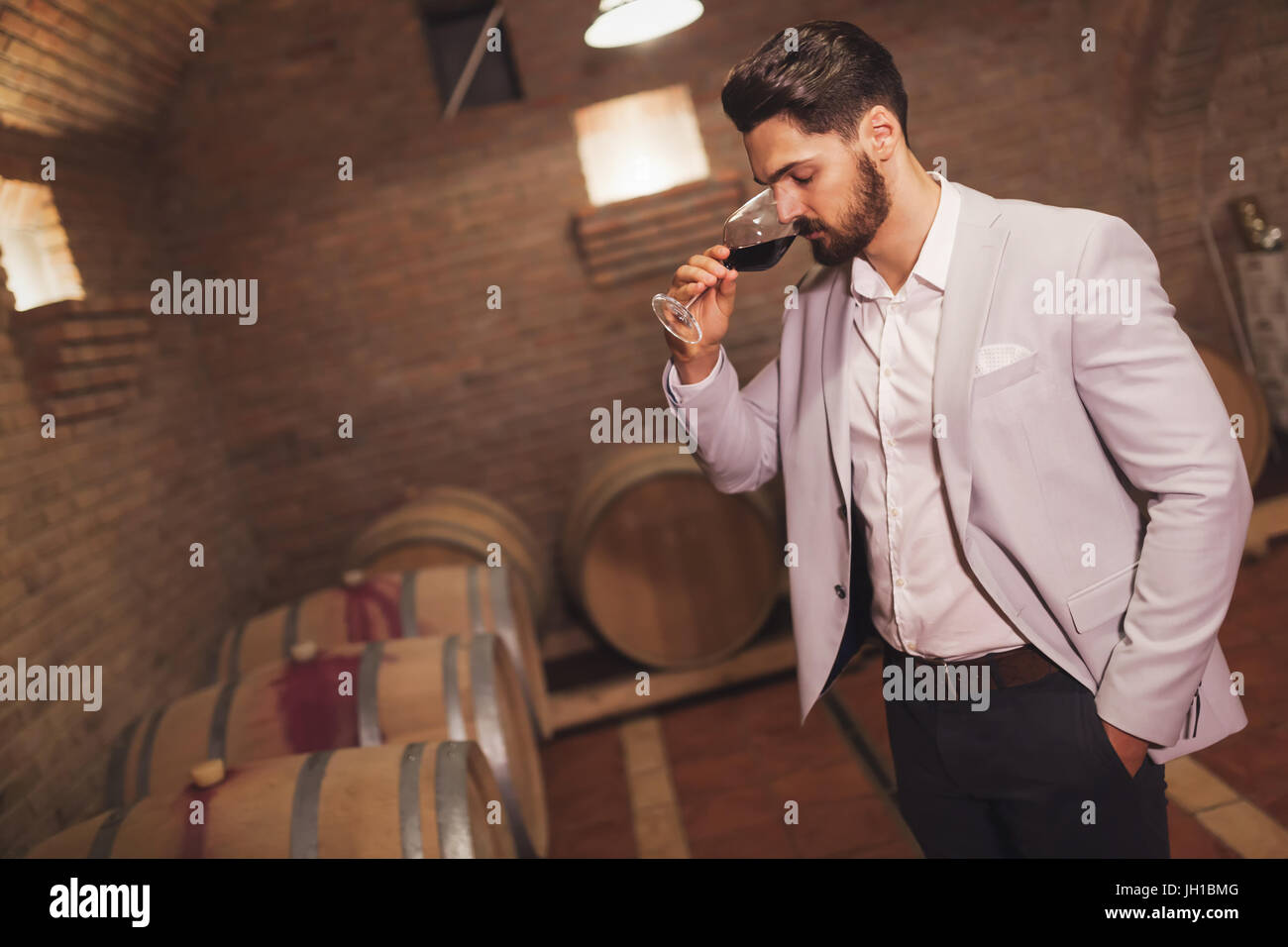 Oenologist tasting wines in cellar Stock Photo - Alamy