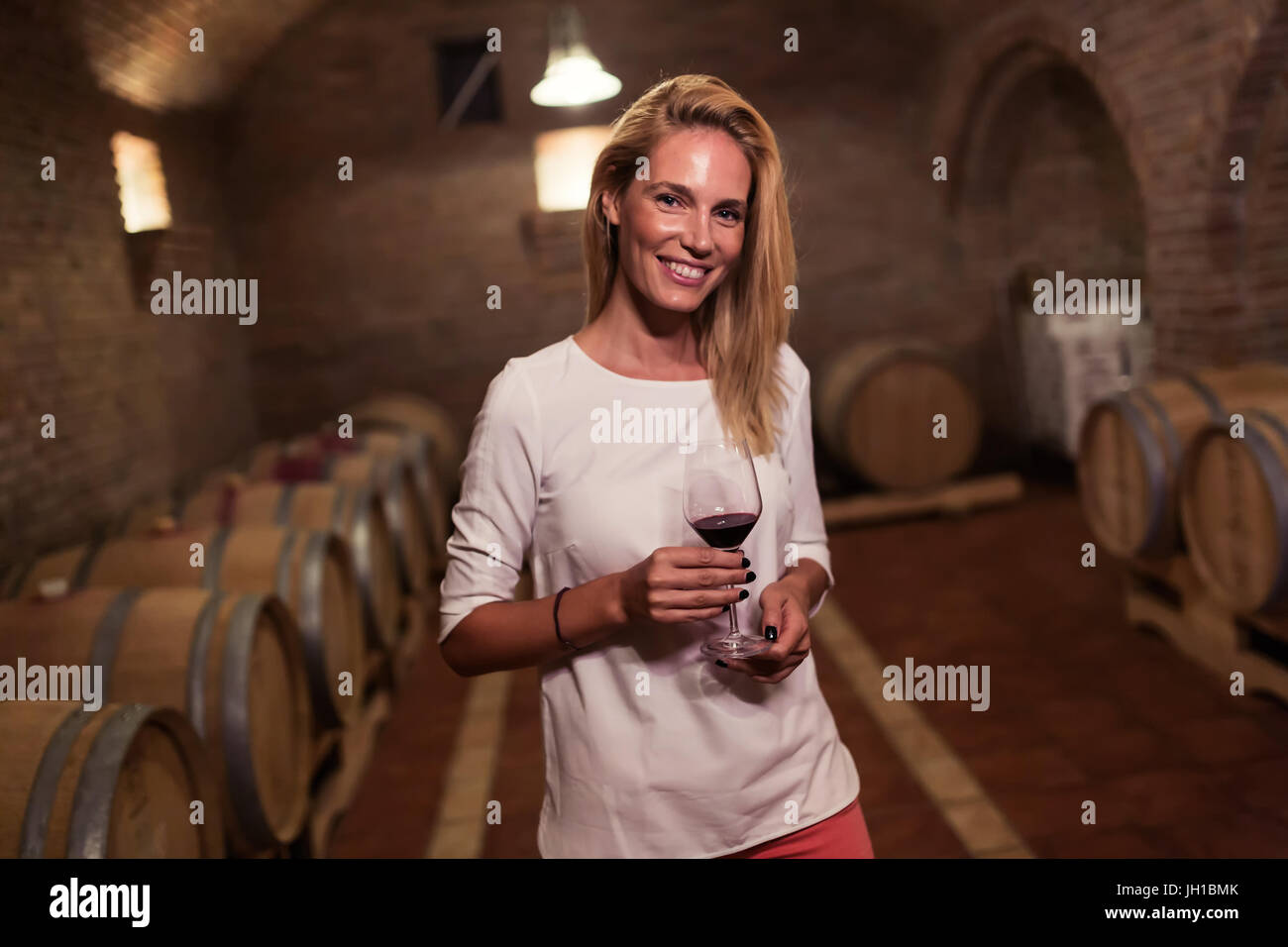 Beautiful woman oenologist tasting wine Stock Photo - Alamy