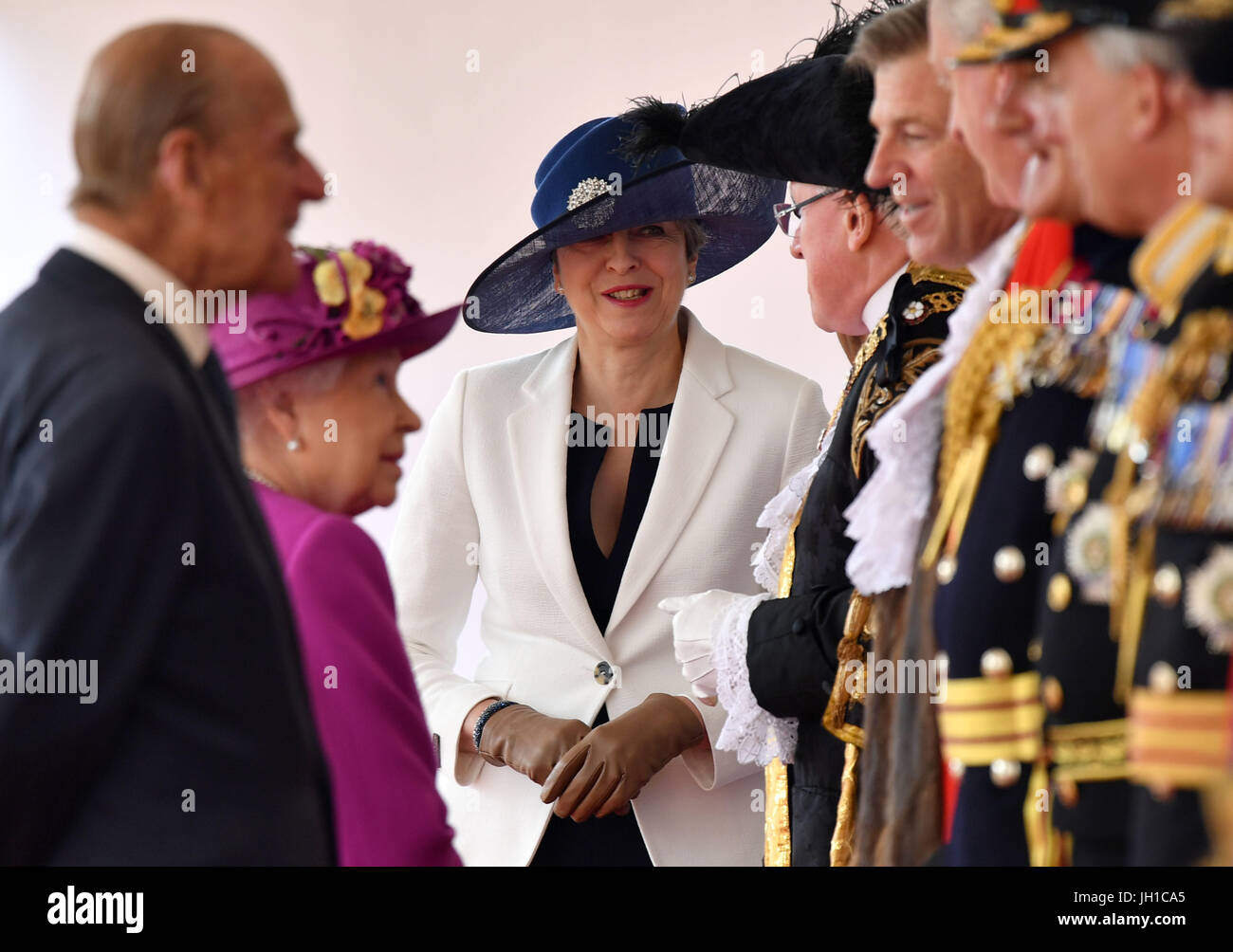 Prime Minister Theresa May looks on as Queen Elizabeth II and the Duke ...