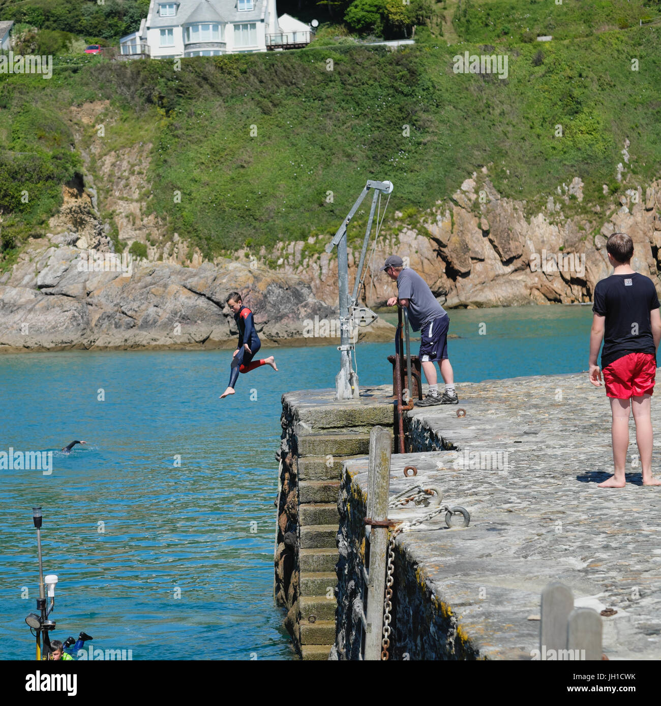 Youngster jumps from quayside Stock Photo - Alamy