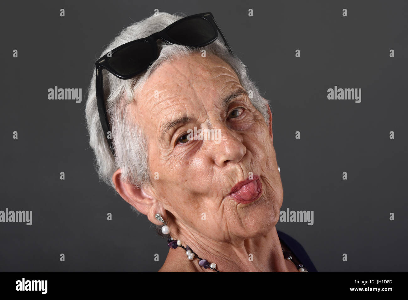 Portrait of senior woman with tongue Stock Photo - Alamy