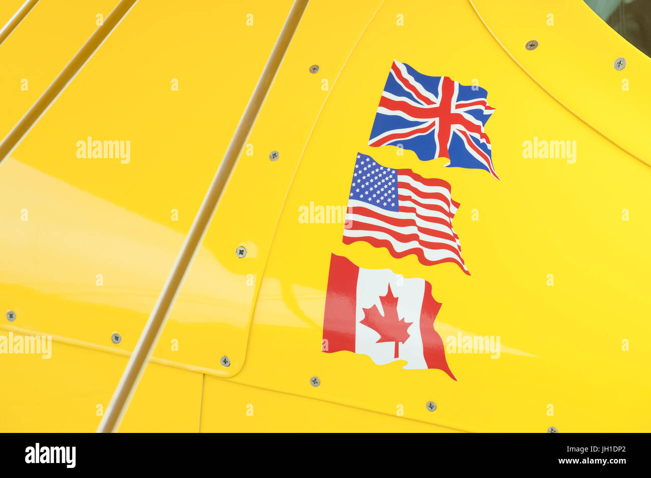 British, American and Canadian flags on a bright yellow metallic ...