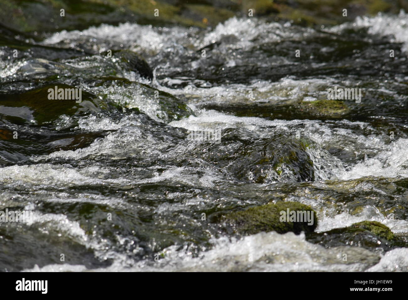 Turbulent water background Stock Photo - Alamy