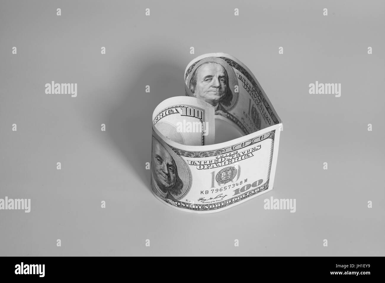 100 dollar bill in heart shape hi-res stock photography and images - Alamy