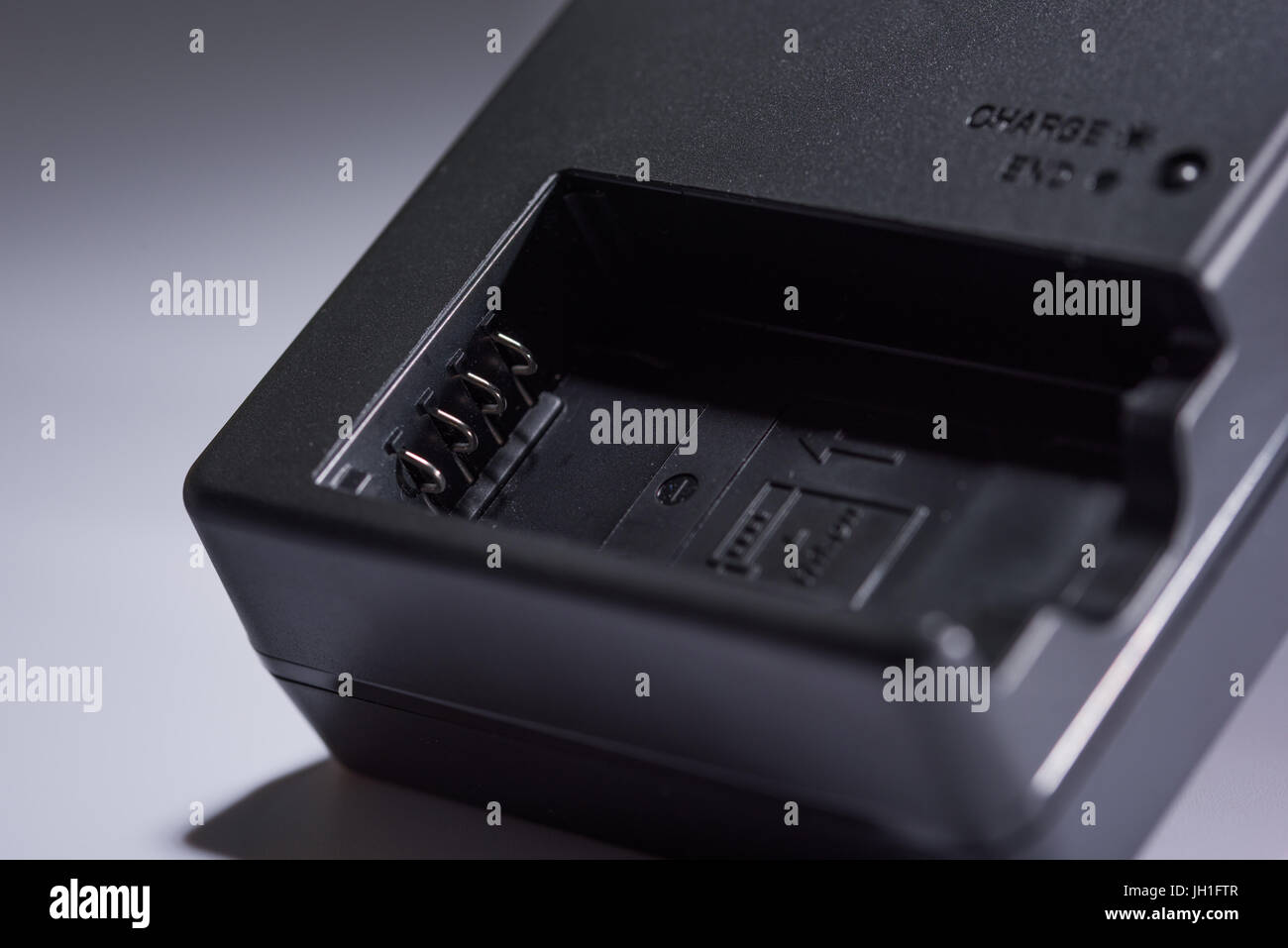 Black camera battery charger Stock Photo - Alamy