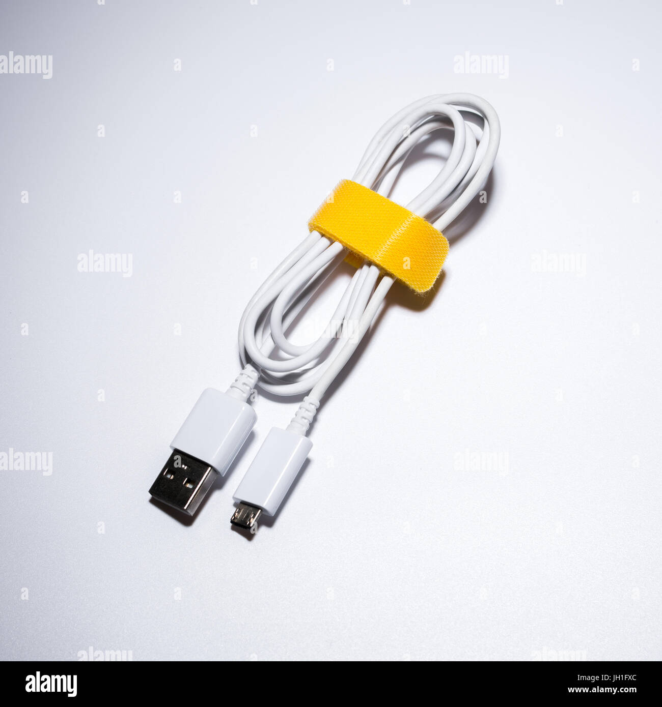 White charging cable for modern smartphone Stock Photo - Alamy