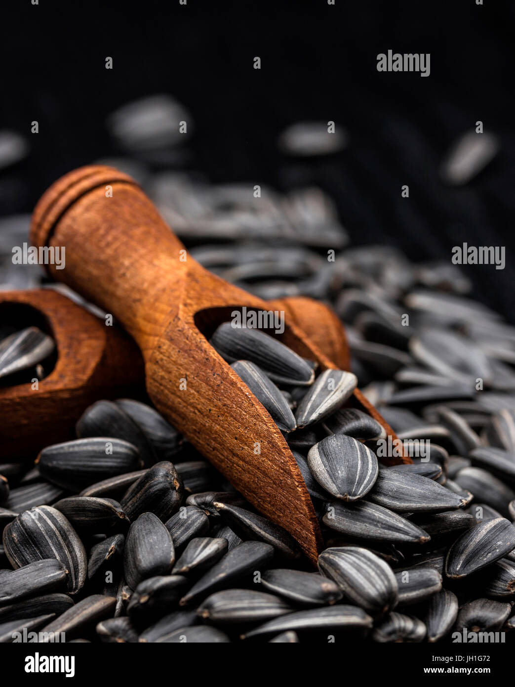 Falling black sunflower seeds close-up on dark background Stock Photo - Alamy