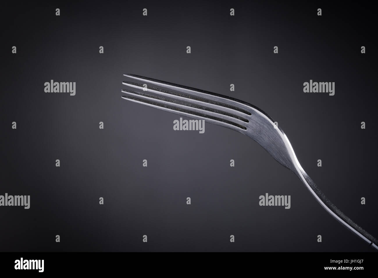 Fork in black background Stock Photo - Alamy