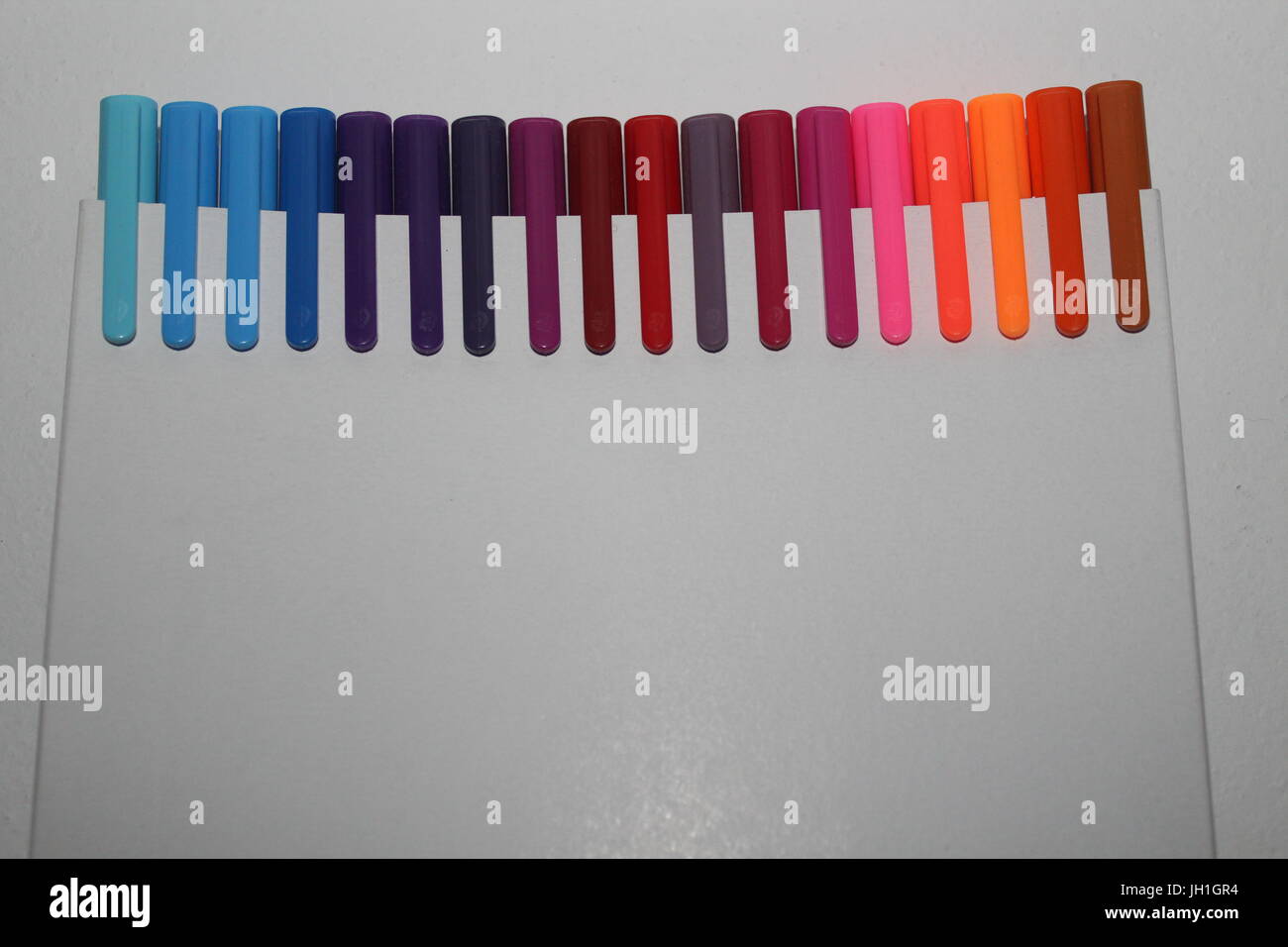Row of pens on white background Stock Photo - Alamy