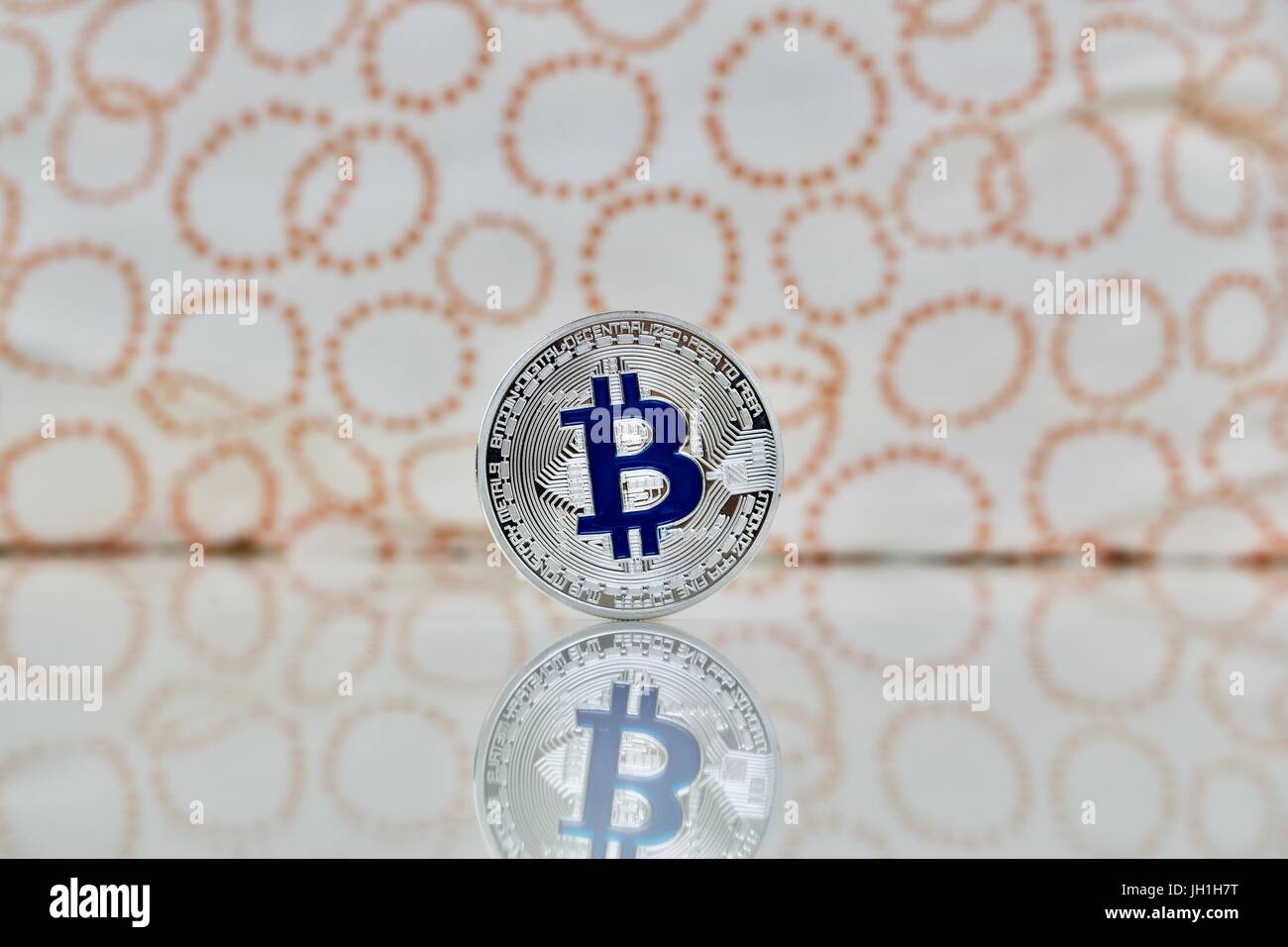 Digital currency physical silver bitcoin coin with blue sign near ...