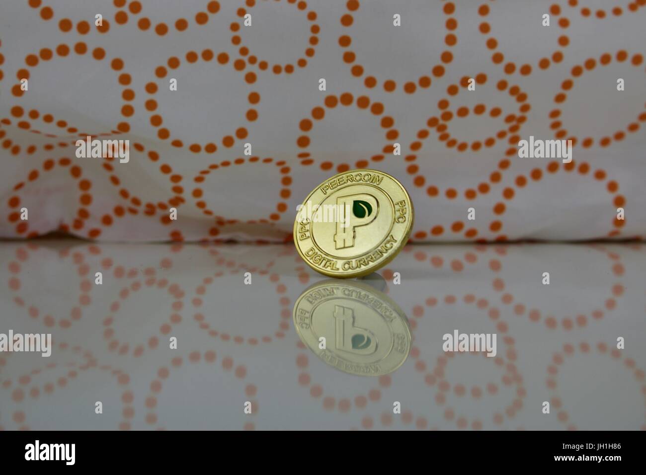 Digital currency physical gold peercoin coin with green leaf in P sign ...