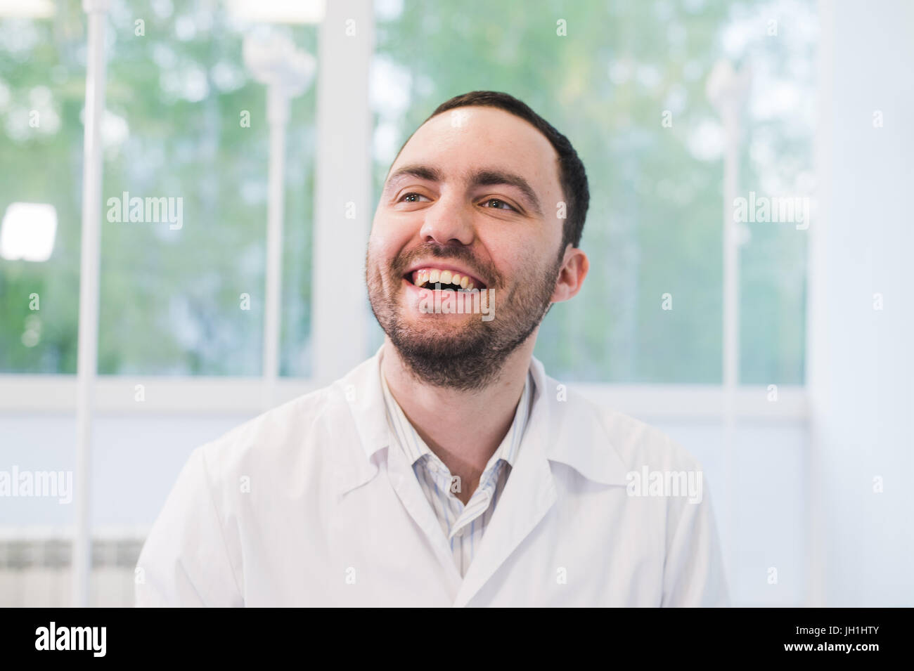 Portrait Of Happy Doctor at hospital ward against window Stock Photo ...