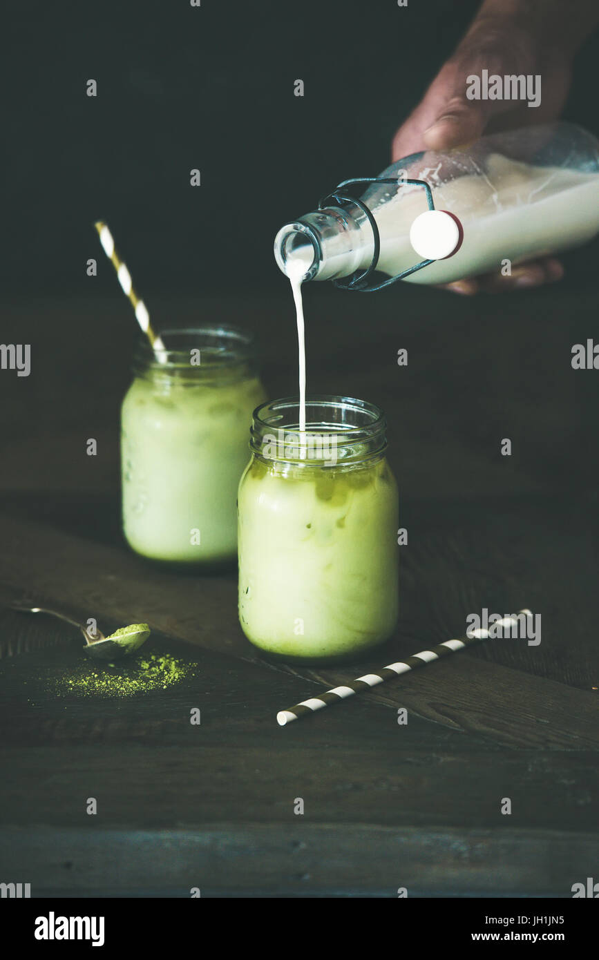 Refreshing iced coconut matcha latte drink in glass jars Stock Photo ...