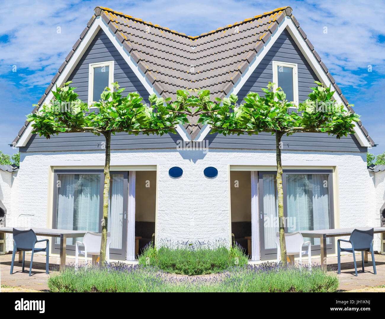 Beautiful holiday house complex with terrace in front of a blue sky ...