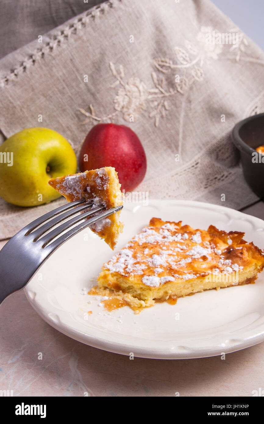 Slice of homemade apple pie on white plate and fork . Homemade freshly ...