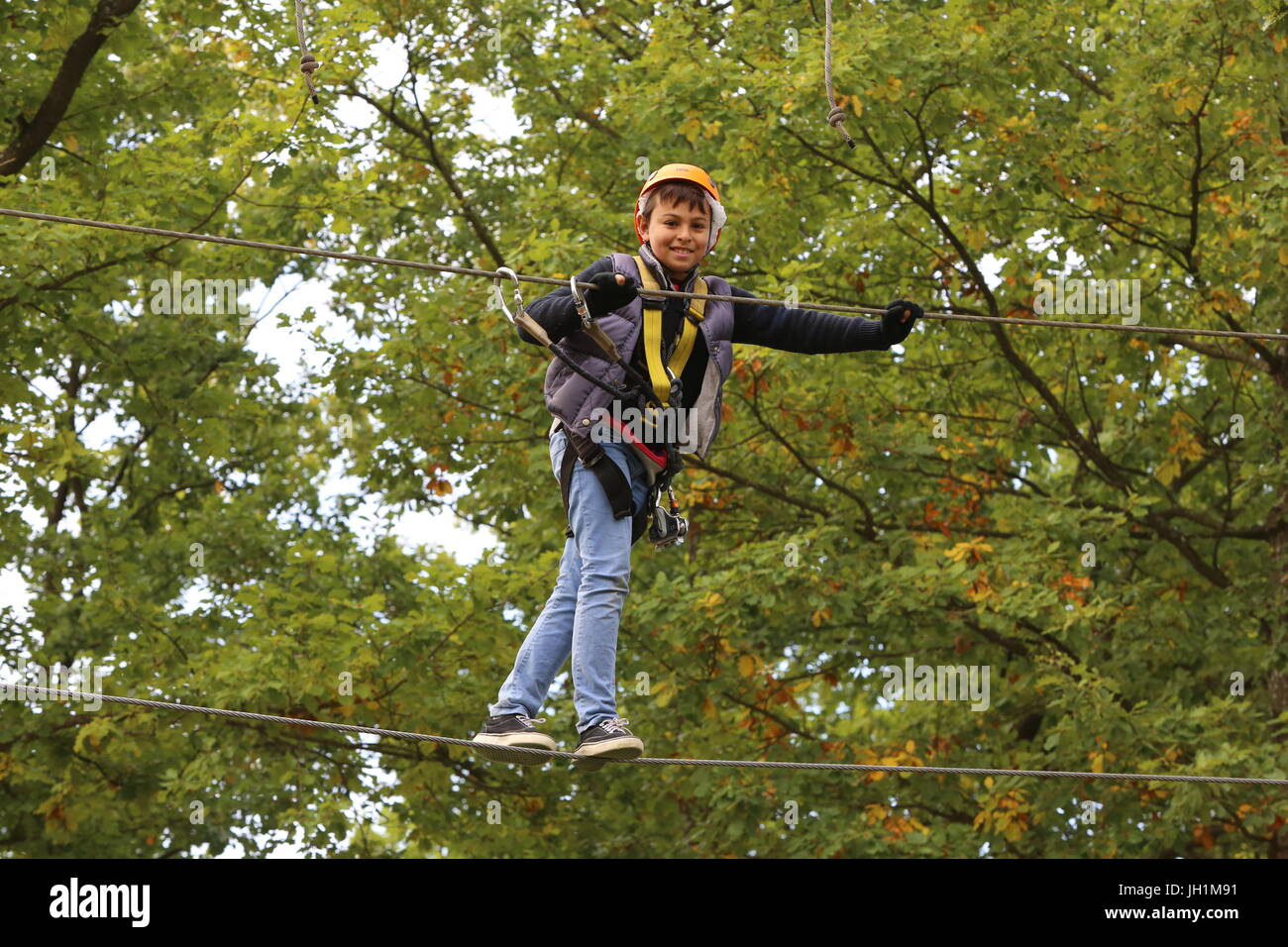 10-year-old boy on a rope course. France Stock Photo - Alamy