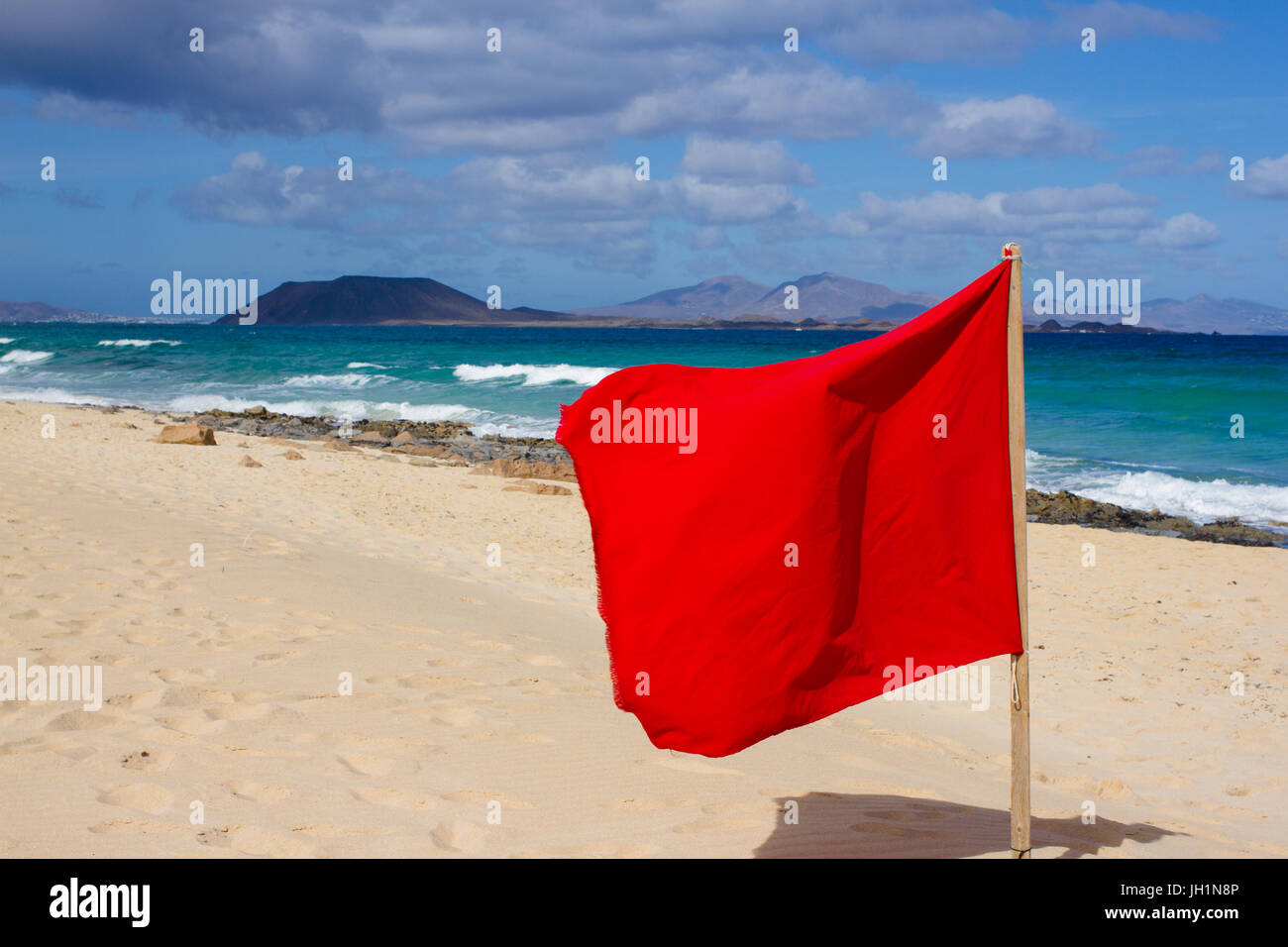 Red flag on beach. Warning sign. Dangerous swim. Safety guard, lifebuoy ...