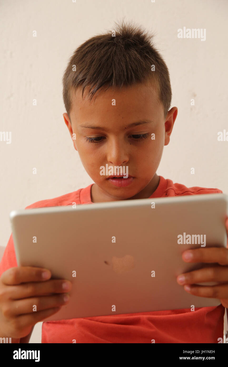 Boy using a digital tablet. Italy Stock Photo - Alamy